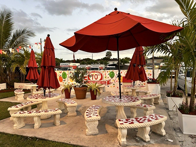 Outdoor seating that celebrates 70 years of feeding Miami. Those red umbrellas have sheltered generations of pizza lovers.