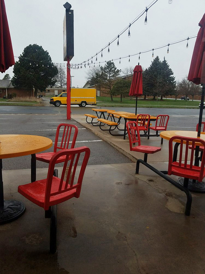 The outdoor seating area with its cherry-red chairs offers a perfect perch for people-watching while tackling burgers that require both hands and several napkins.