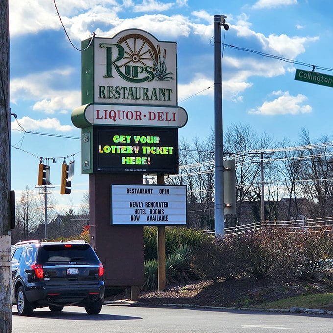The roadside sign announces "Restaurant, Liquor, Deli" like a holy trinity of essential services for the hungry traveler.