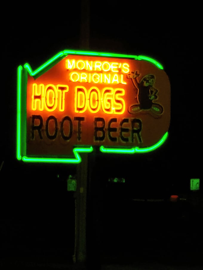 The neon glow acts like a lighthouse for hungry travelers, beckoning with promises of comfort food that have remained unchanged for generations.