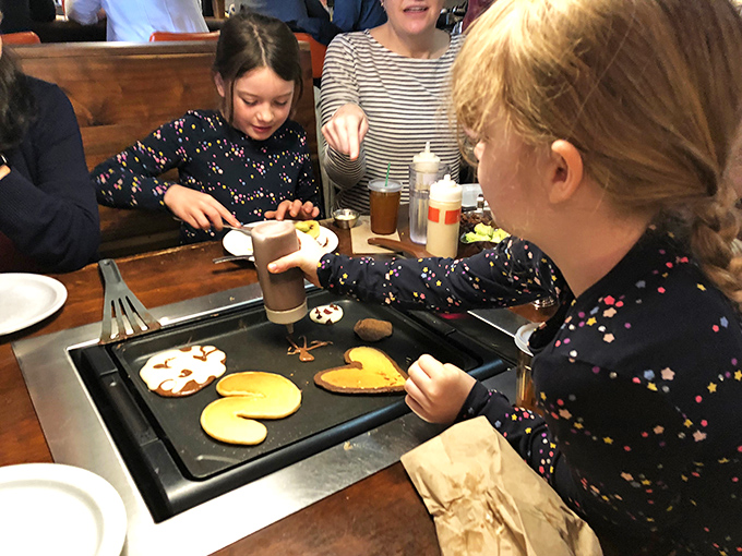 Little hands creating edible masterpieces. Those Mickey Mouse pancakes will be remembered long after the taste fades.
