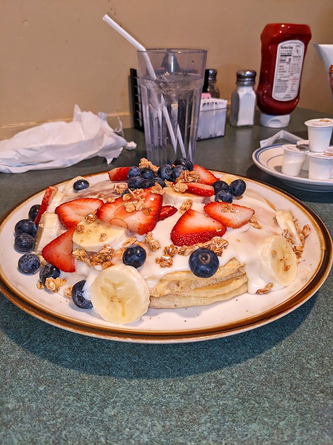 Yogurt parfait artistry that turns breakfast into a celebration. Those fresh fruits and granola create a textural symphony that makes waking up early almost worth it.