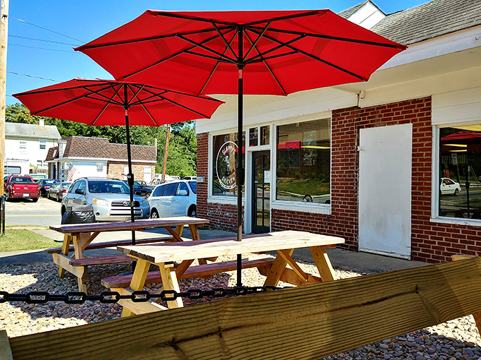 The outdoor seating area where chicken dreams come true under bright red umbrellas. Even al fresco dining gets the Slappy's treatment.