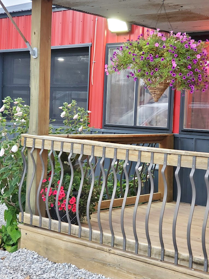 Hanging flower baskets and wooden railings add touches of warmth to the porch &ndash; your first hint that attention to detail extends beyond the kitchen.