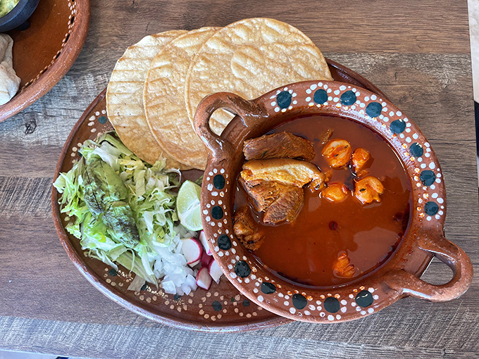 Traditional Mexican stew served in decorative pottery with all the fixings&mdash;it's like a warm hug in food form.