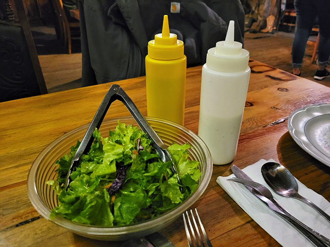 A dining room where strangers become friends, united by the shared experience of tackling meals that could feed a small village.