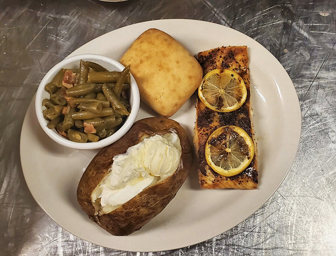 Lemon-kissed salmon, a loaded baked potato, and green beans with bits of ham&mdash;proof that "non-fried" at The Catfish Hole is anything but punishment.