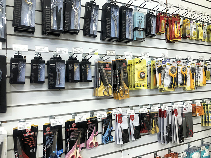 Tools of the trade, hanging like specialized equipment for fabric surgeons. Each one designed to make your sewing dreams come true.