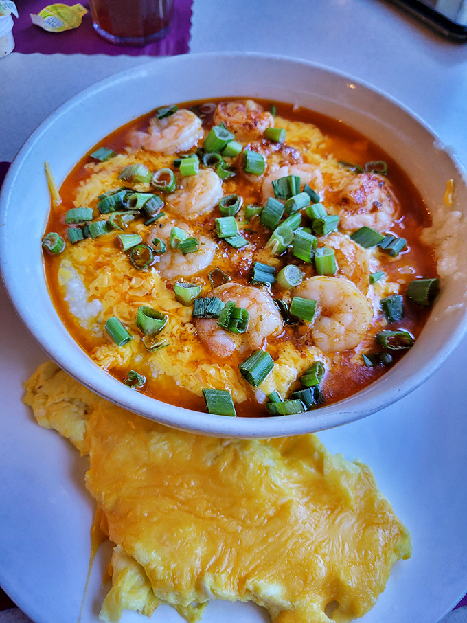 Shrimp and grits: where the ocean meets the farm. Those plump shrimp swimming in savory sauce atop creamy yellow grits is Southern poetry on a plate.
