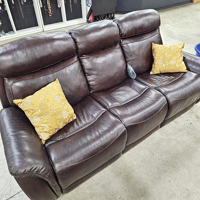 This leather sofa has already been broken in for you, those yellow pillows adding a touch of "I definitely meant to design it this way."