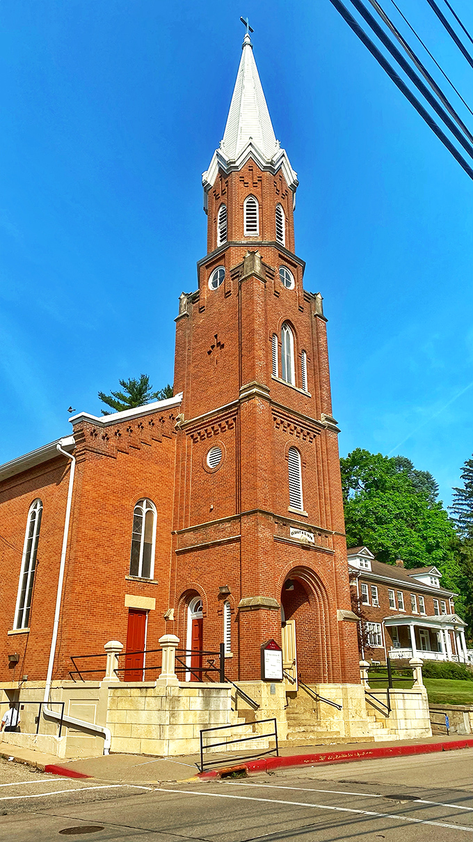 This red brick spire reaches heavenward like an ecclesiastical exclamation point, announcing faith with architectural confidence rather than whispers.