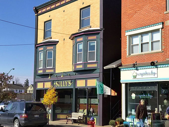 Sully's Irish Pub sits nestled between colorful storefronts, beckoning passersby with promises of hearty fare and pint-lifting camaraderie.