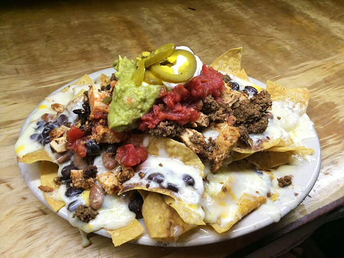 Nachos that laugh in the face of moderation. Every chip is a treasure hunt where X marks the spot with guacamole, jalape&ntilde;os, and all things holy.