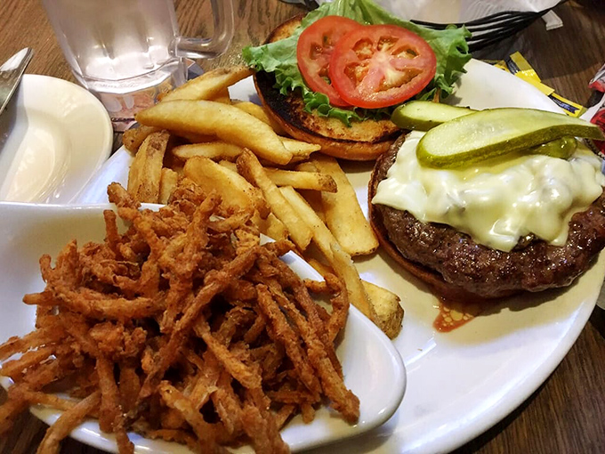 This burger isn't just topped with cheese&mdash;it's wearing a crown. The crispy onion straws are the royal entourage.