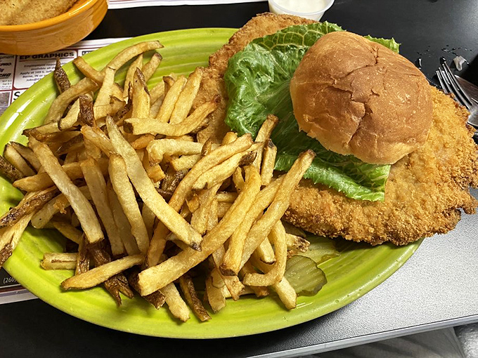 The legendary tenderloin sandwich&mdash;a golden-fried masterpiece that refuses to be contained by mere bread. Those hand-cut fries aren't just sides, they're co-stars.