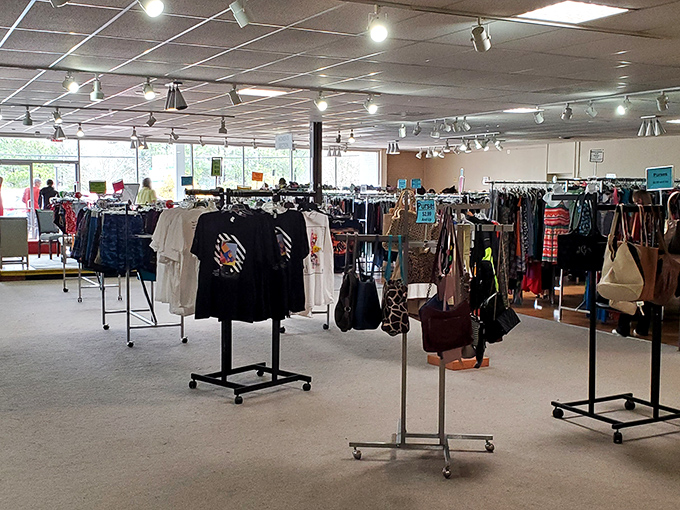 The clothing department stretches toward infinity, a textile galaxy where vintage band shirts orbit alongside last season's fashion trends.