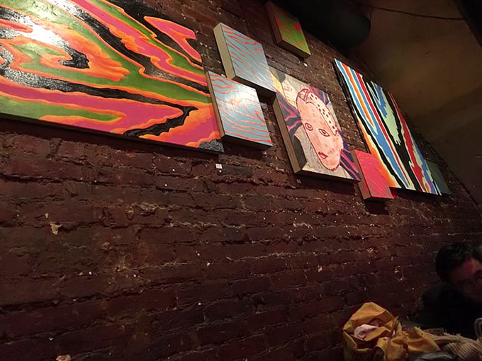 The gallery wall changes regularly, showcasing local artists who pay their tab in creativity and color rather than cash.