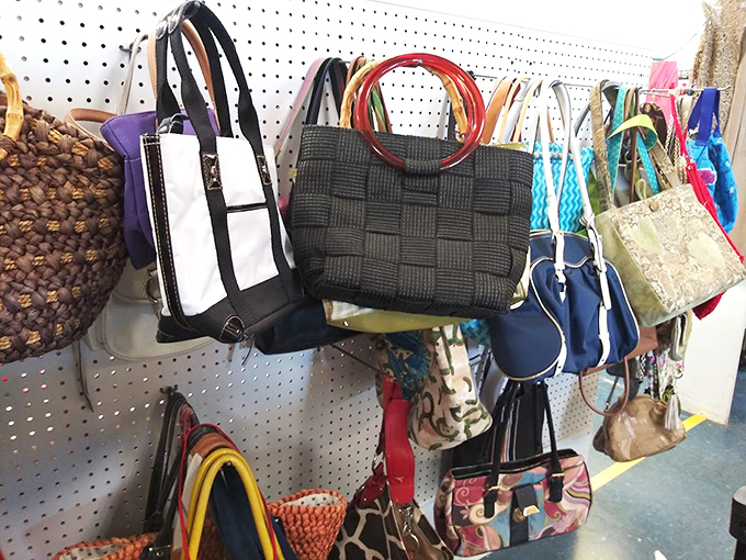 Handbags hanging like exotic fruit, ready to be plucked by someone who appreciates that vintage Coach is actually better than the new stuff.