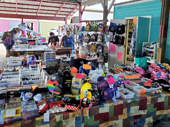 Vibrant stalls burst with color as vendors arrange their wares with practiced precision. The pastel buildings create a distinctly Florida backdrop for serious bargain hunting.