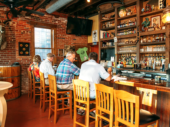 The well-stocked bar is where locals gather, proving that in small towns, the best conversations happen over good drinks.