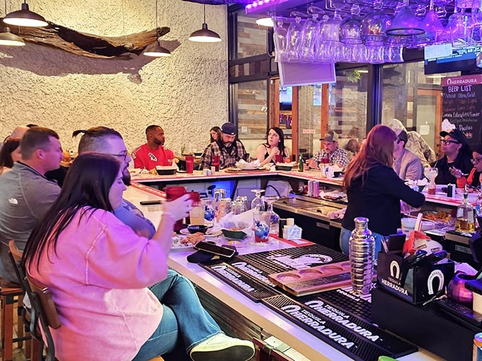 Where culinary magic happens—the bar area buzzes with energy as patrons gather for margaritas and Mexican-inspired camaraderie.