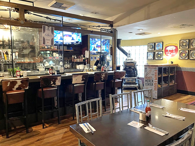 The bar area promises liquid courage before facing plates that require their own ZIP code. Those cow-print stools know what's coming.