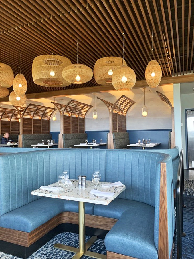 Those curved blue booths aren't just seating&mdash;they're front-row tickets to the greatest show on earth: the Pacific Ocean in all its moody glory.