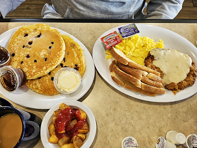 Breakfast of champions: blueberry pancakes, country fried steak with gravy, and home fries that could fuel you through anything the day throws your way.
