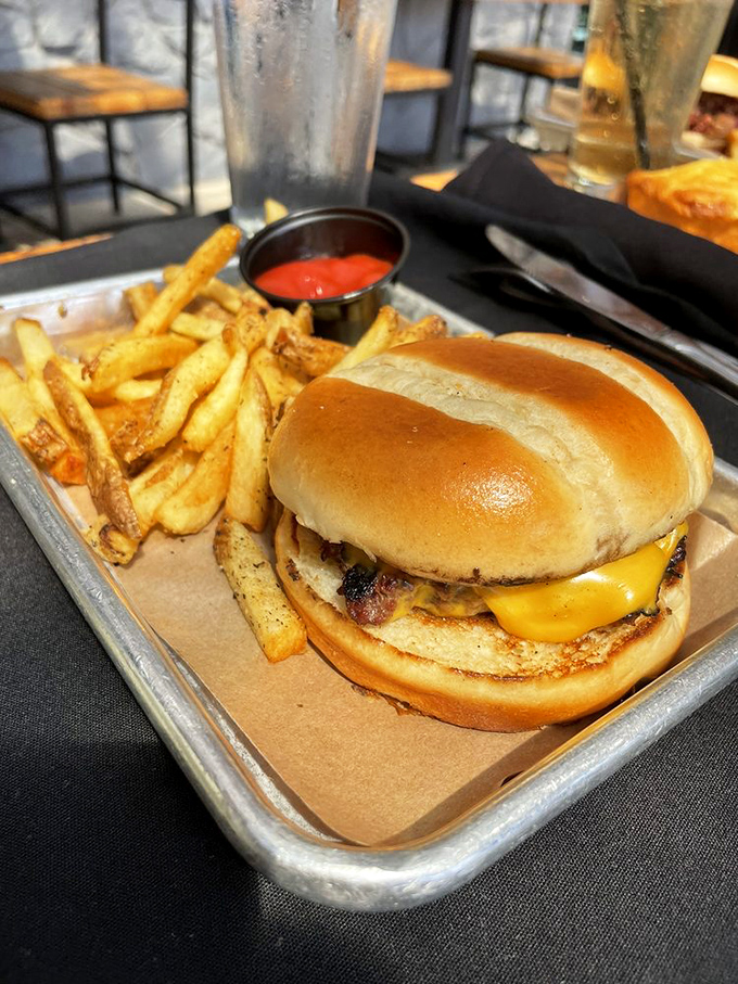 A burger that doesn't apologize for joining a barbecue menu, flanked by fries that know exactly what they're doing.
