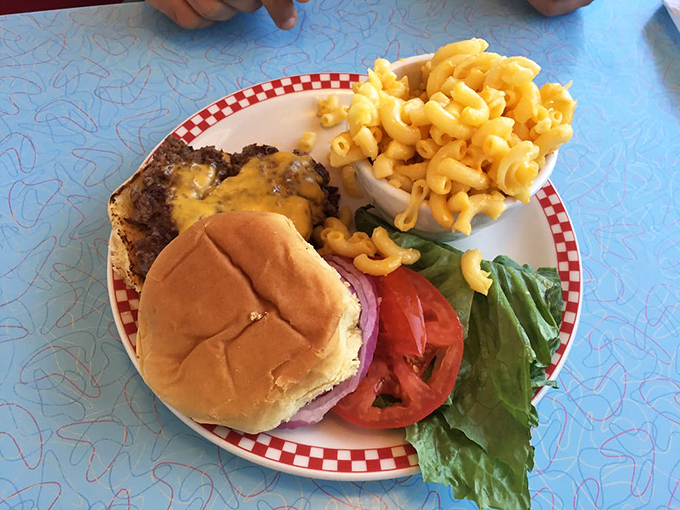 When lunch calls at Broadway Diner, this burger answers—melted cheese cascading down the patty while mac and cheese stands by for carb-loading reinforcements.
