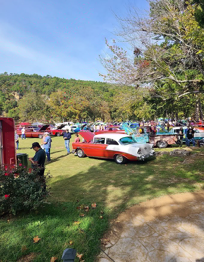 Classic cars line up under autumn trees during one of Wilburton's community events, chrome gleaming like it's still 1957.