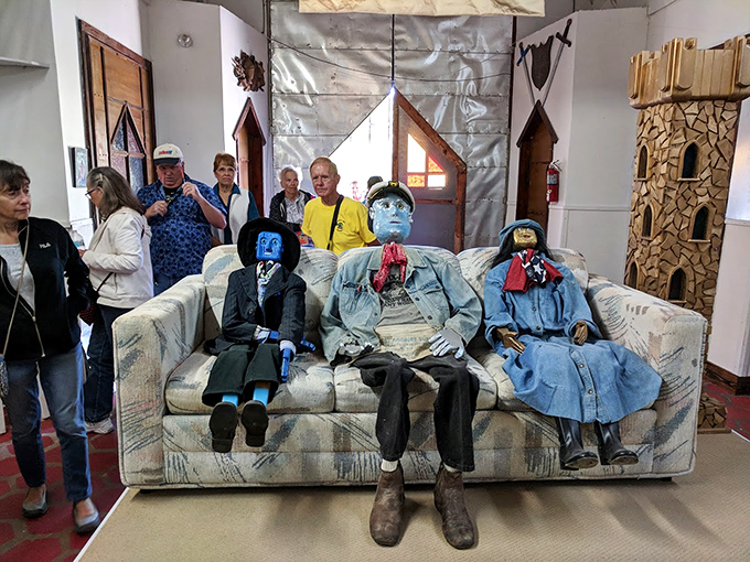 The "Blue Family" lounges eternally on this couch, silently judging your tourist attire while visitors snap photos of Solomon's peculiar household.