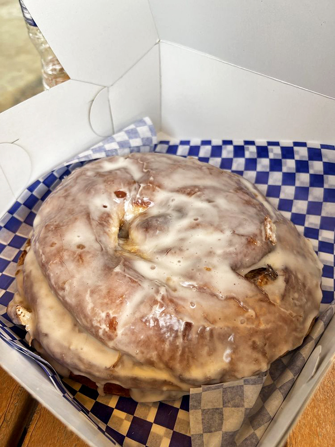 This cinnamon roll looks like it's wearing a cozy sweater of glaze. It's the pastry equivalent of a warm hug on a chilly morning.