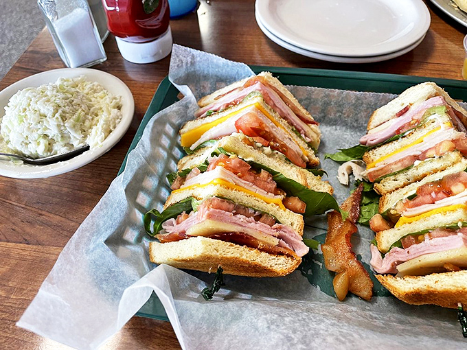 The club sandwich&mdash;architectural marvel of the diner world&mdash;stands proudly with layers of ham, turkey, and bacon in perfect harmony.