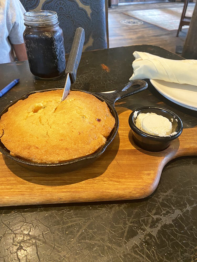 Cornbread served in a cast iron skillet isn't just food&mdash;it's Southern poetry, especially when there's a scoop of butter slowly melting into its soul.