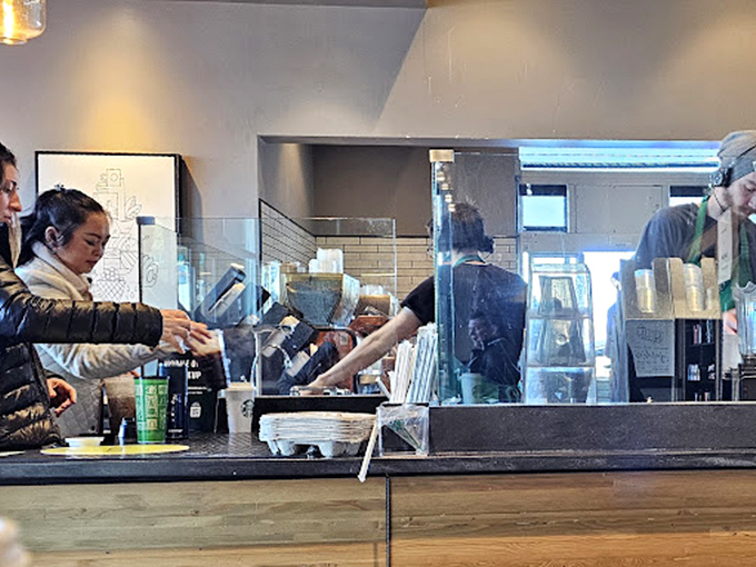 Behind the scenes at Mel's, where the magic happens &ndash; staff moving with practiced efficiency while customers perch at the counter, waiting for their slice of diner heaven.