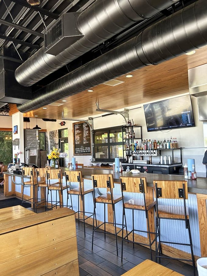 The bar isn't just where drinks happen&mdash;it's front-row seating to barbecue ballet, with industrial chic meeting warm wood in perfect harmony.