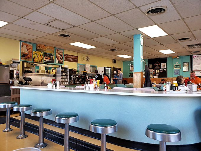 The counter where solo diners never eat alone. These stools have hosted first dates, business deals, and countless "just coffee, please" that turned into breakfast.