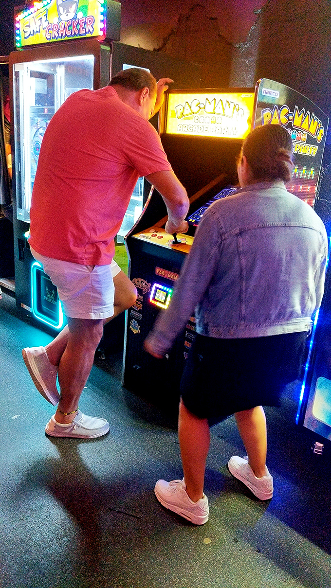Pac-Man fever is still highly contagious as these gamers demonstrate, locked in concentration on the classic yellow dot-muncher.