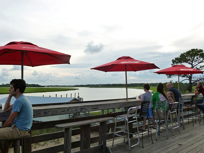 The deck where time slows down and conversations flow as easily as the tidal waters stretching to the horizon.