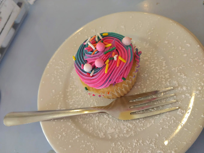 A cupcake that doesn't know the meaning of subtlety. Those sprinkles aren't just toppings&mdash;they're tiny confetti celebrating your excellent dessert choice.