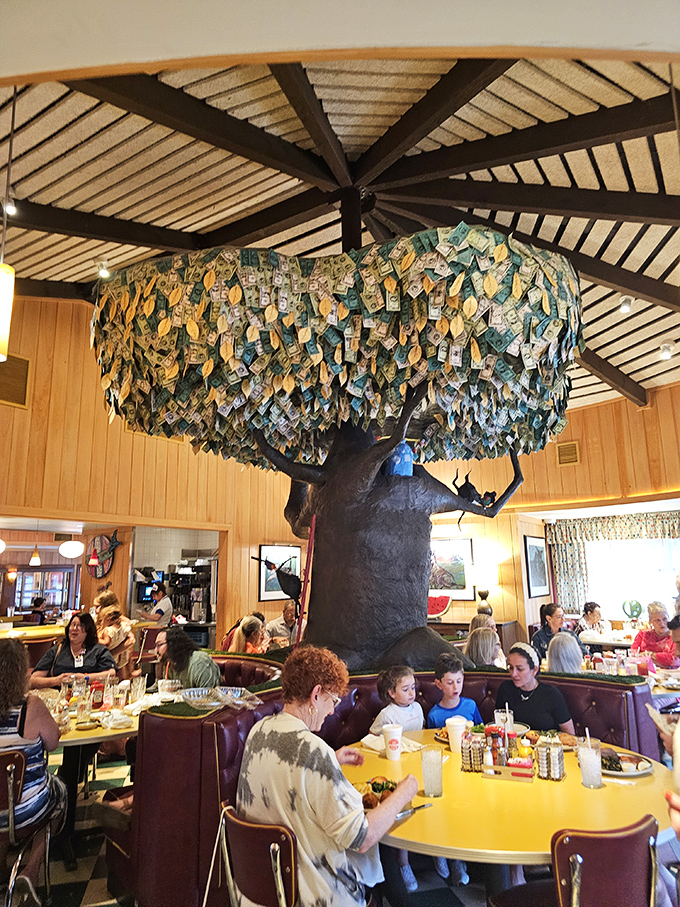The money tree centerpiece isn't just decoration &ndash; it's where diners pin dollar bills, creating a canopy of cash and memories above yellow tables.
