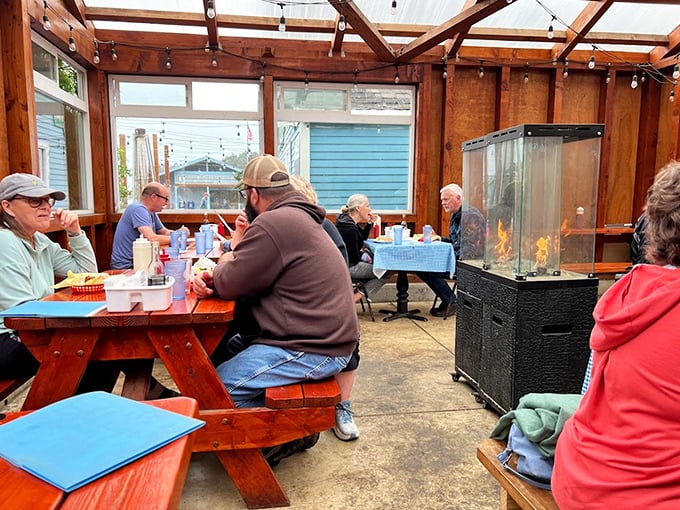 The covered patio where locals and tourists alike huddle around wooden tables, united by the universal language of great seafood.