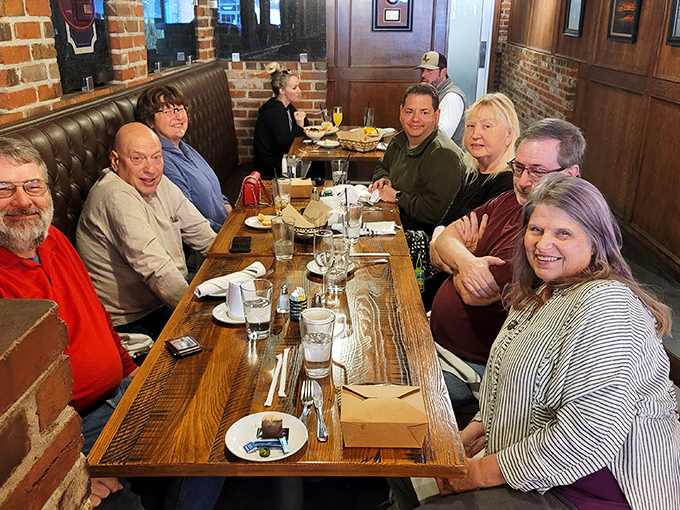 Happy diners, can't lose! This group looks more satisfied than a cat in a sunbeam, proving that good food brings people together.