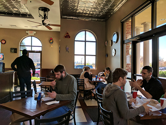 Fellow diners lost in sandwich bliss&mdash;a community united by the universal language of "mmm" and strategically placed napkins.