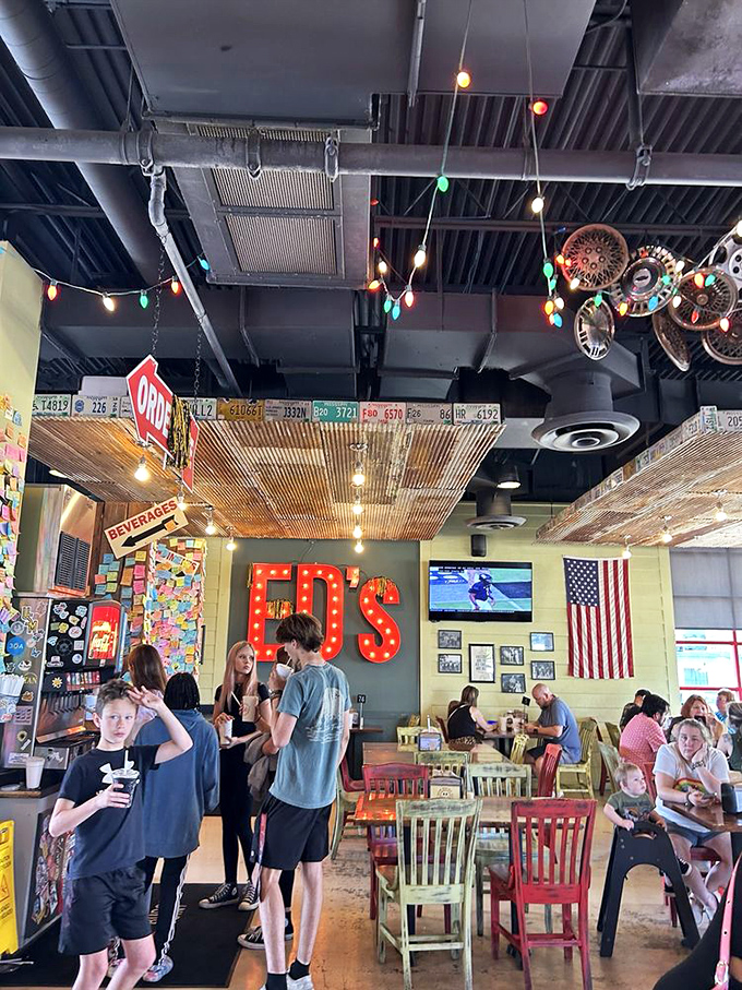 Ed's dining room buzzes with the energy of people making memories. That iconic red sign watches over it all like a benevolent burger deity.