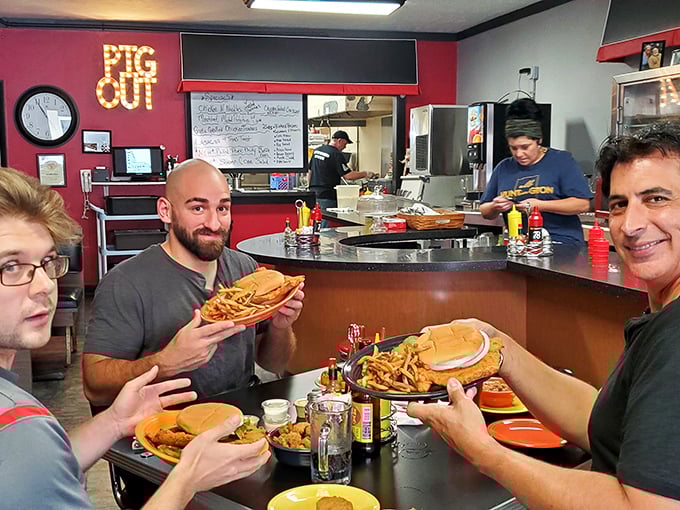 When food becomes an event worth documenting. In the background, the "PIG OUT" sign offers both instructions and permission.
