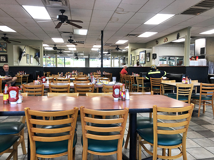 The dining room hums with anticipation, wooden chairs and tables standing ready for the seafood pilgrims who know what's good.