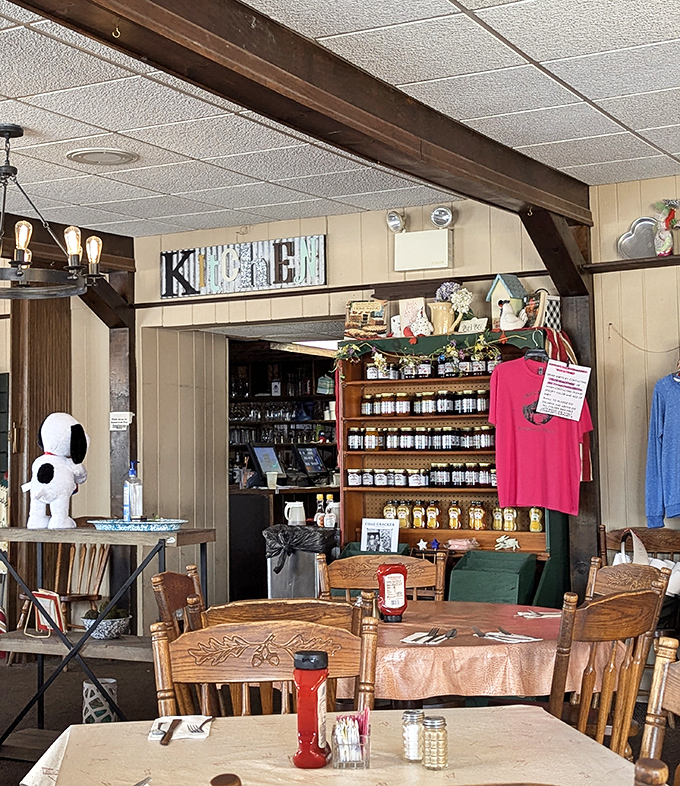 The "KITCHEN" sign and shelves of homemade preserves remind you that this isn't corporate food—it's cooking that comes from tradition and heart.