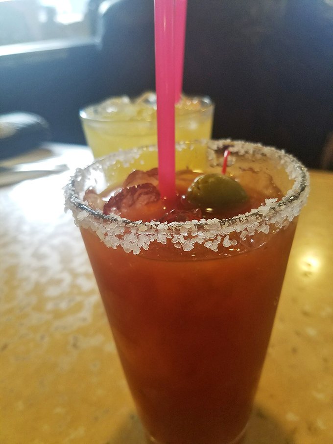 A Bloody Mary with enough garnish to count as a small meal. The salt rim isn't just decoration—it's an essential supporting character.
